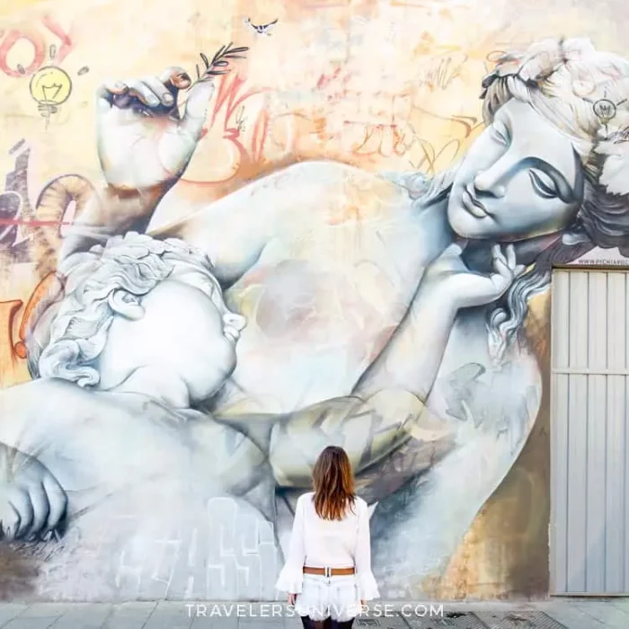 A street art mural in Valencia depicting a mother and child