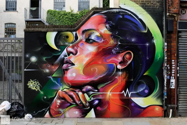 A street art mural depicting a colorful woman profile in Shoreditch, one of London's hip neighborhoods
