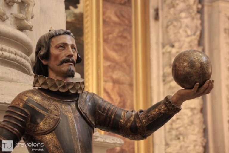 Statue of Christopher Columbus holding the globe in his hand inside Seville's Cathedral