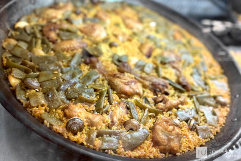 An authentic paella Valenciana in its pan, which fun fact is also called paella