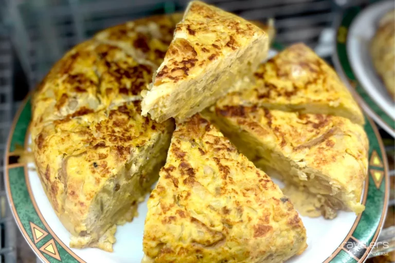 Slices of tortilla de patatas, one of the  most traditional Spanish foods, on a plate 