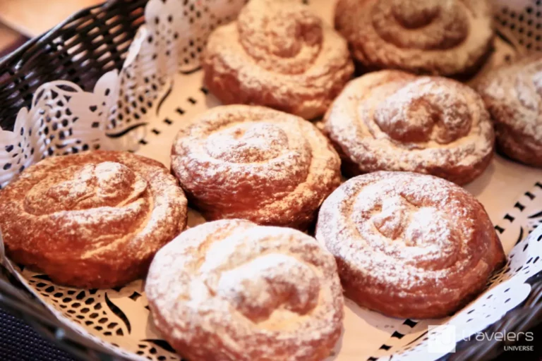 Spanish breakfast ensaimada pastries with powdered sugar in a basket