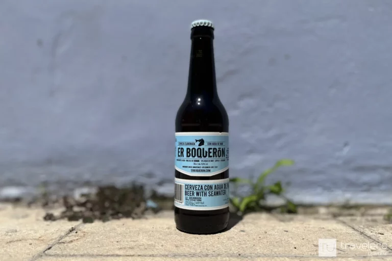 A bottle of Er Boquerón Spanish beer with a blue wall as a background