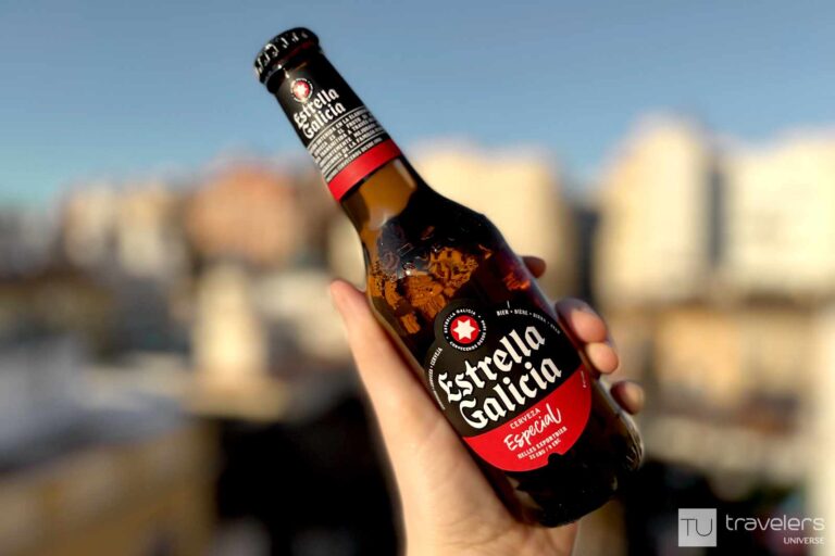 A hand holding a bottle of beer, one of the most popular drinks in Spain