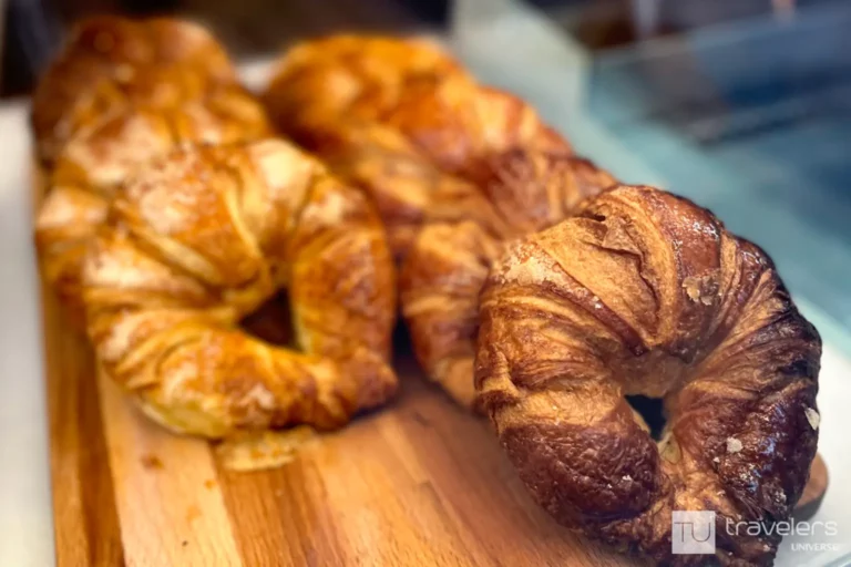 Curved croissant on a wooden board
