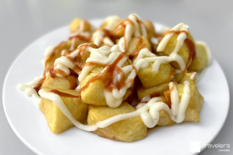 Patatas bravas on a white plate - the perfect answer to the what are tapas question