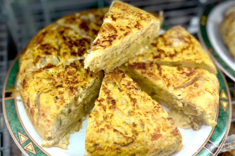 Slices of tortilla de patatas on a white and green plate 