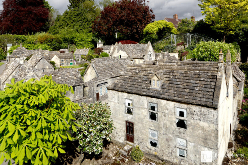 Miniature houses surrounded by bonsai-like trees at the Model Village in Bourton on the Water