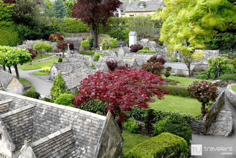 Panoramic view of Bourton on the Water with a red maple tree in the middle at the Model Village in Bourton on the Water