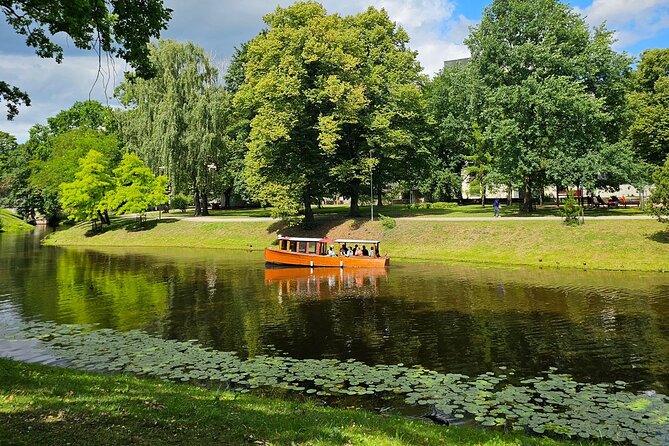Riga Canal and Daugava Boat Tour with Welcome Drink & Audio Guide - Key Points