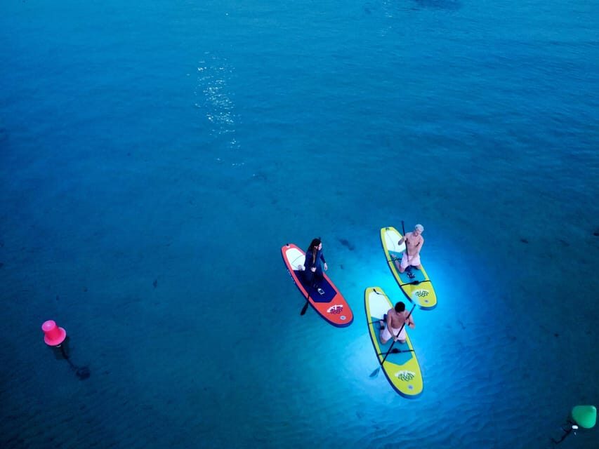 Paddle Surf with Led lights at sunset in Menorca - The Highlights of Menorca Sunset Paddle Surfing