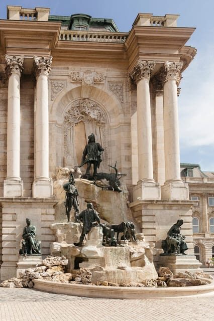 Budapest: Buda Castle Walking Tour & Folk Music Performance - Walking Through Architectural Diversity on Tárnok Street