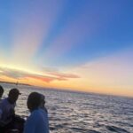 Sunset Party open bar on the bay while sharing with locals - The Sum Up