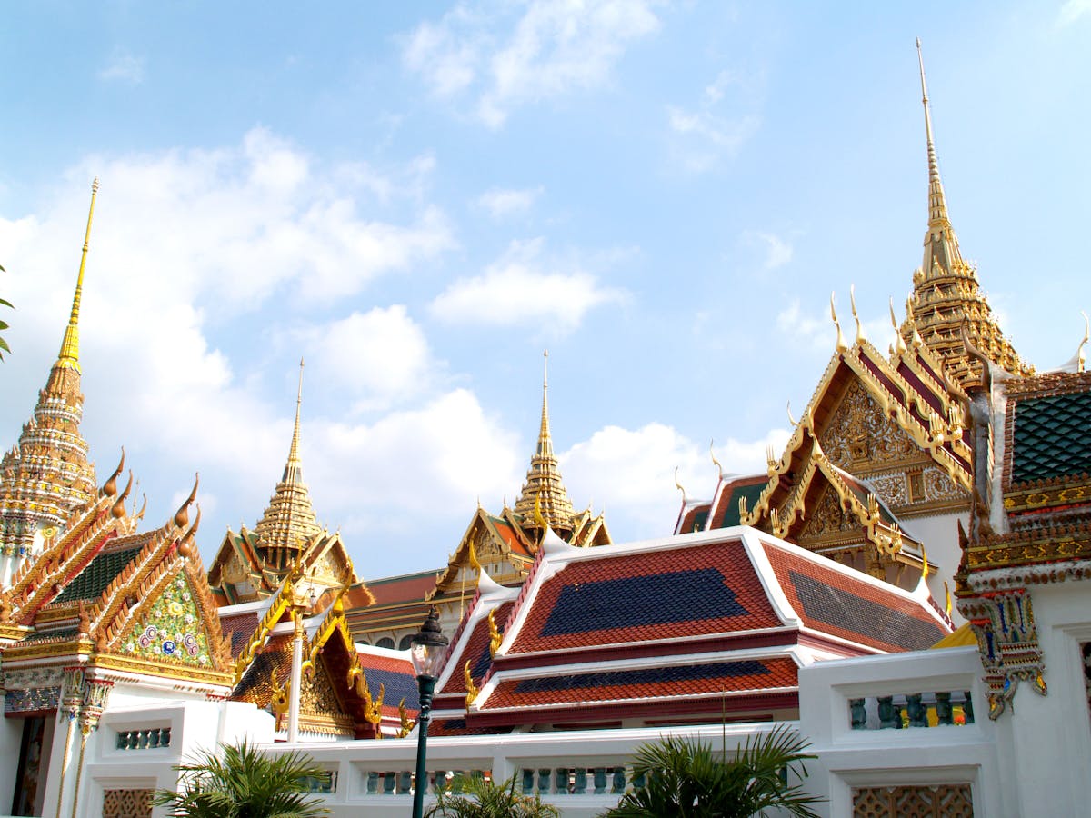 Grand Palace complex in Bangkok with golden spires and ornate rooftops