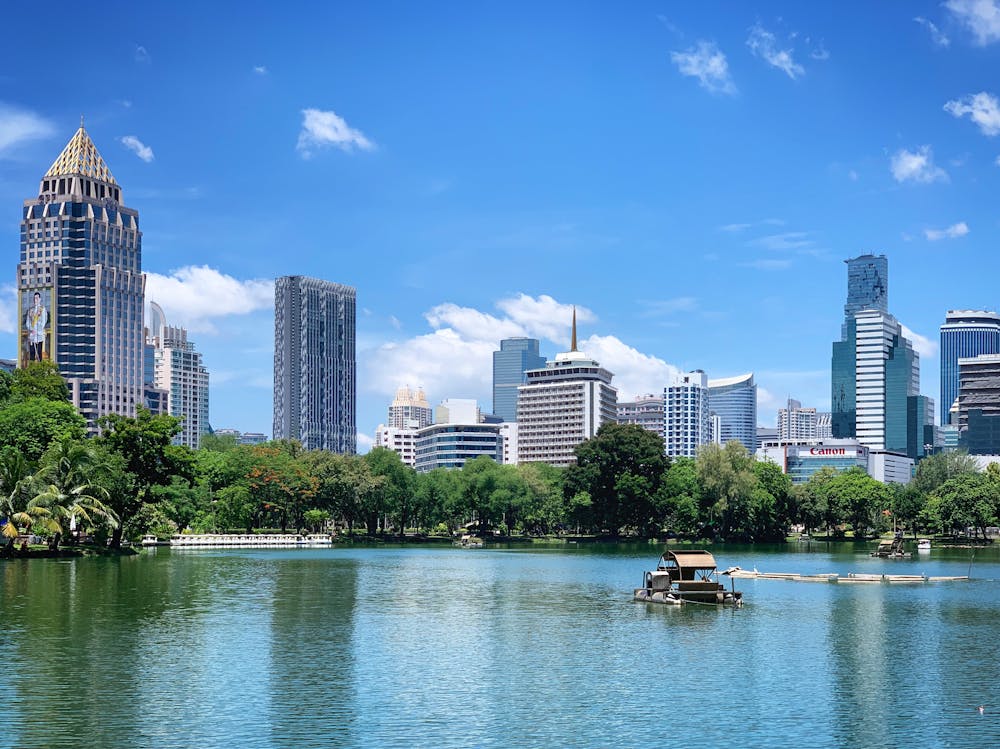 Lumpini Park lake and skyline in central Bangkok