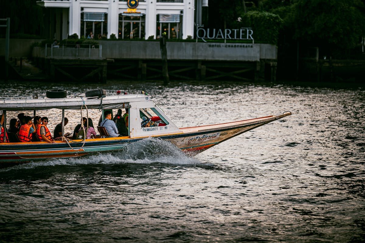 Longtail boat carrying passengers on the Chao Phraya River in Bangkok