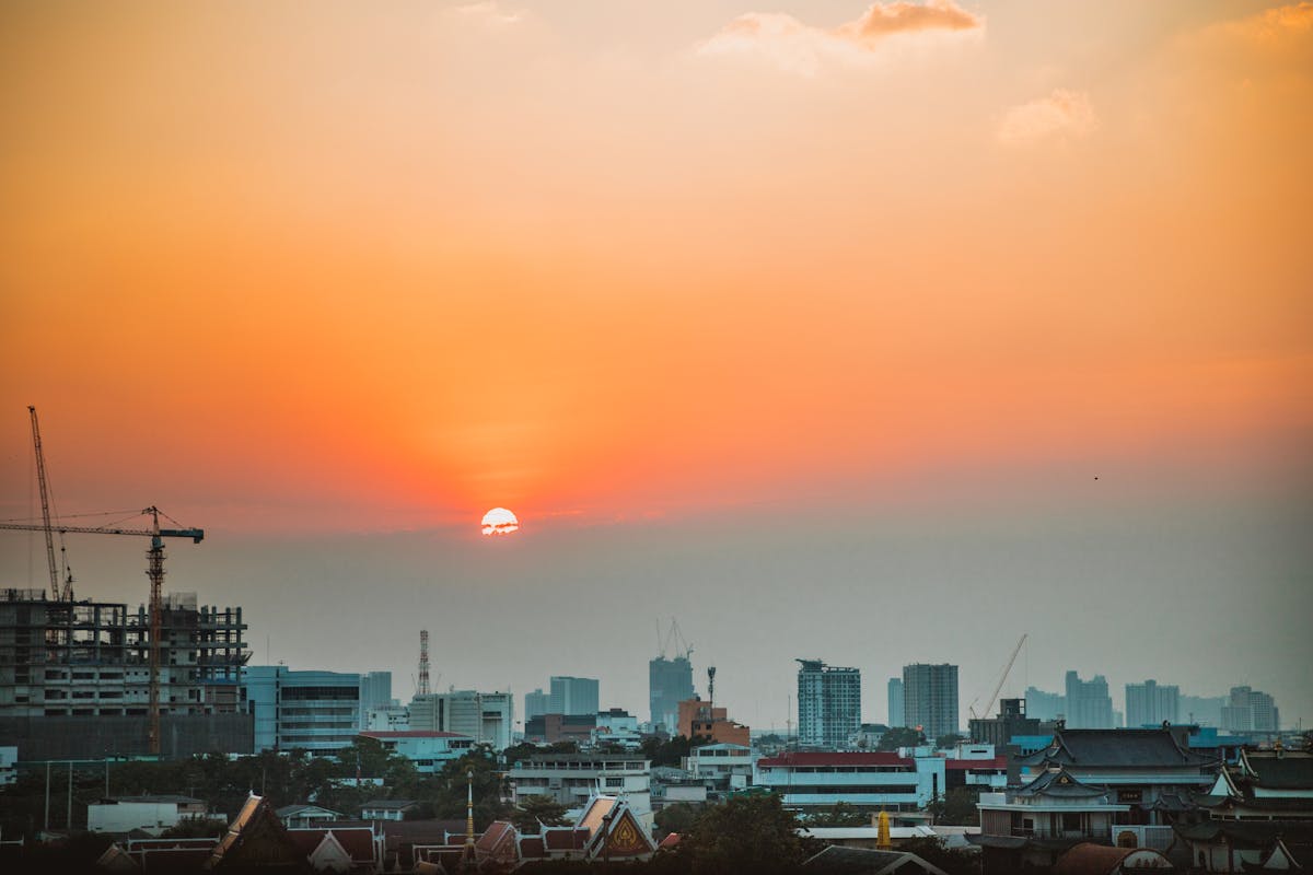 Bangkok city skyline at sunset viewed from a rooftop bar