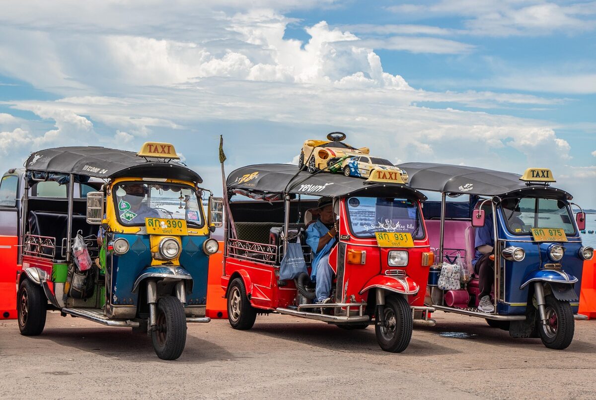 Colorful tuk-tuks parked on a Bangkok street