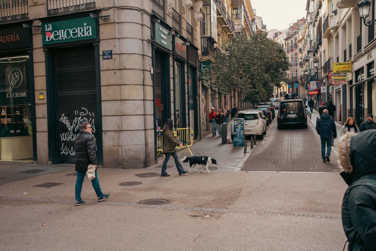 Pedestrians walking along a Barcelona street near La Rambla