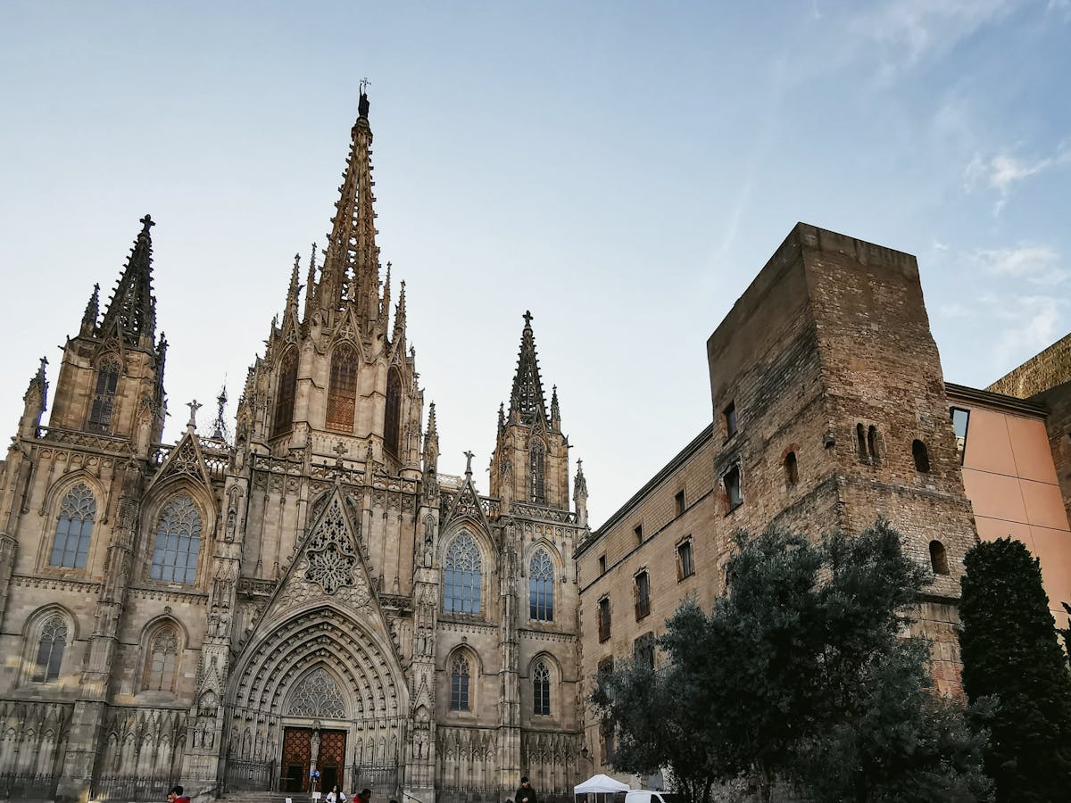 The Gothic facade of Barcelona Cathedral against a bright blue sky
