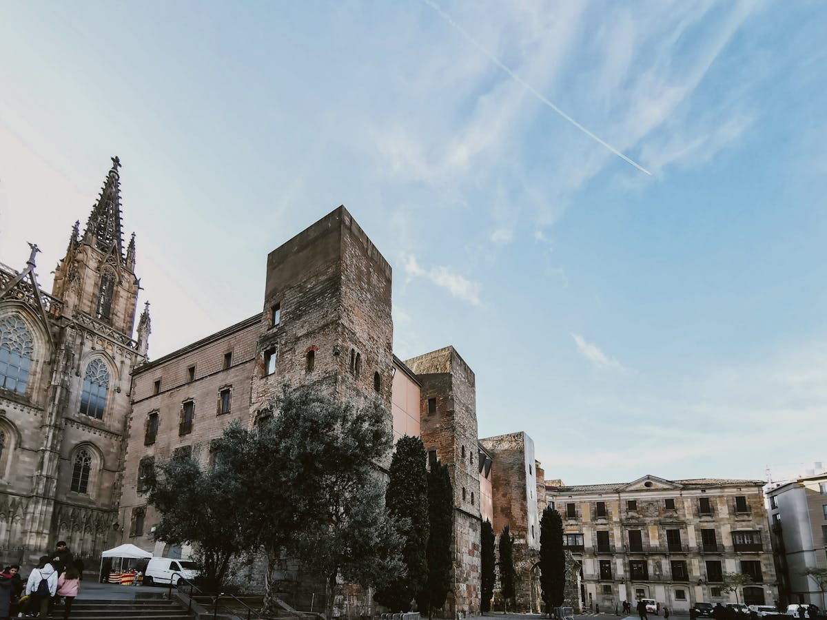Historic Gothic architecture in the old quarter of Barcelona against a blue sky
