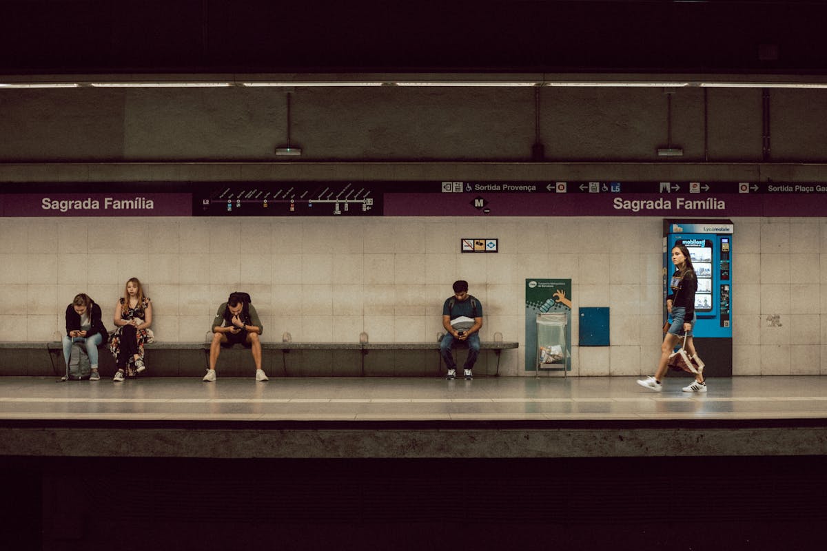 Commuters at the Sagrada Familia metro station platform in Barcelona