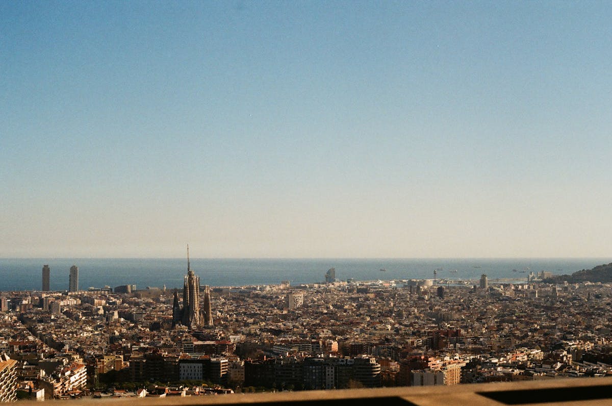 Panoramic view of Barcelona skyline with the Sagrada Familia and the Mediterranean Sea in the background