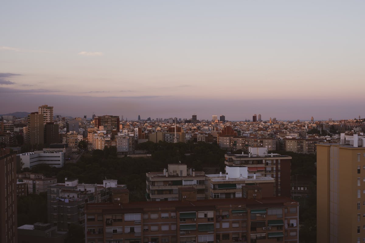 Overview of Barcelona architecture and rooftops as twilight falls over the city