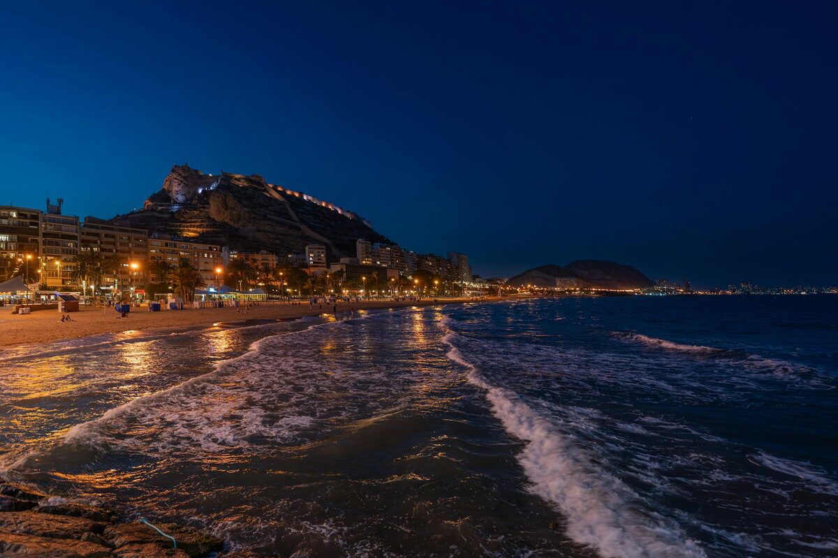 Alicante coastline with Santa Barbara castle illuminated at dusk