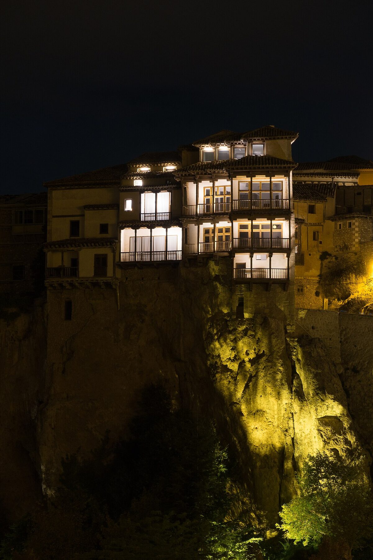 Hanging houses of Cuenca illuminated against the gorge at night