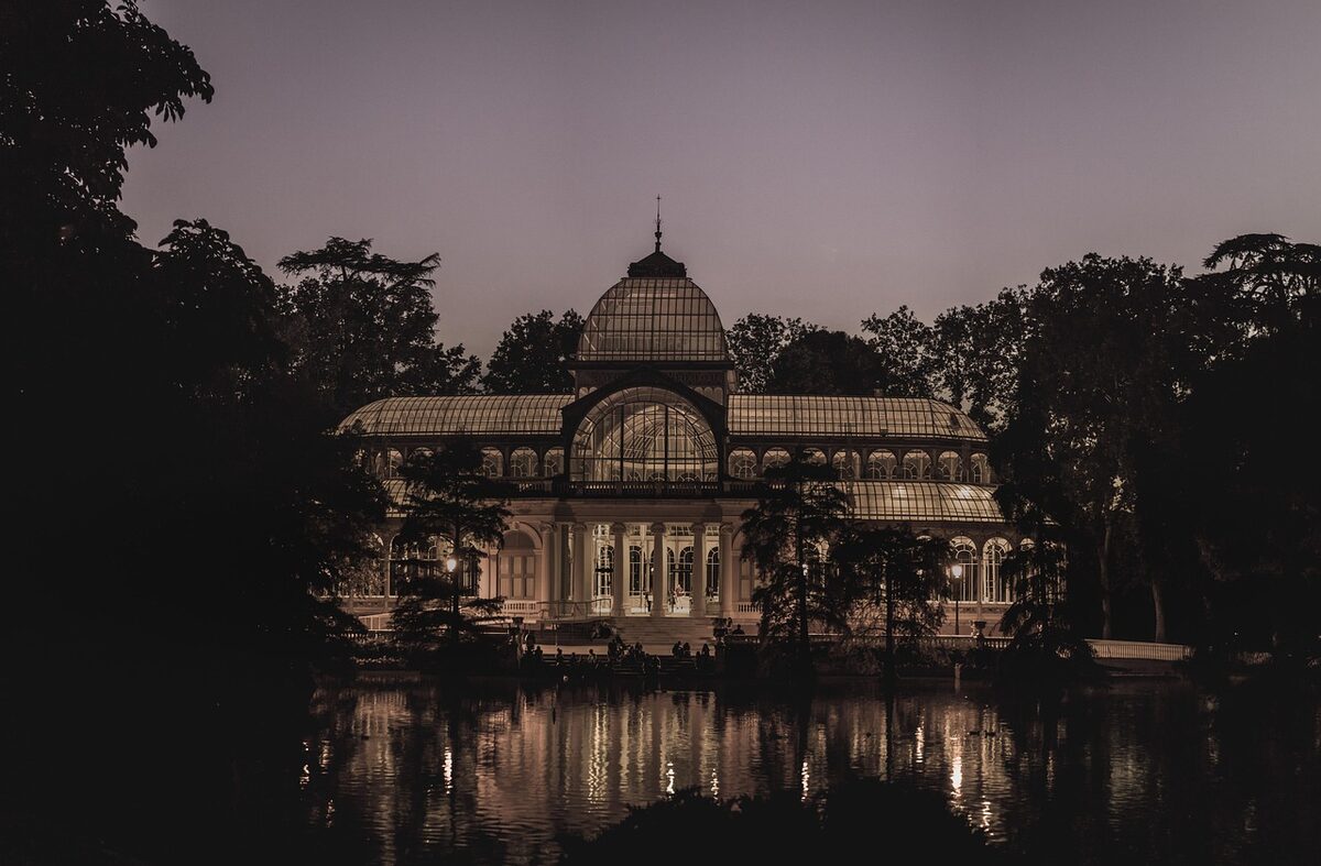 Crystal Palace in Retiro Park Madrid reflected in the lake at dusk