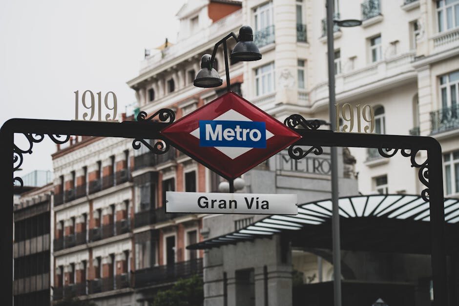 Gran Via Metro station entrance in Madrid with historic buildings