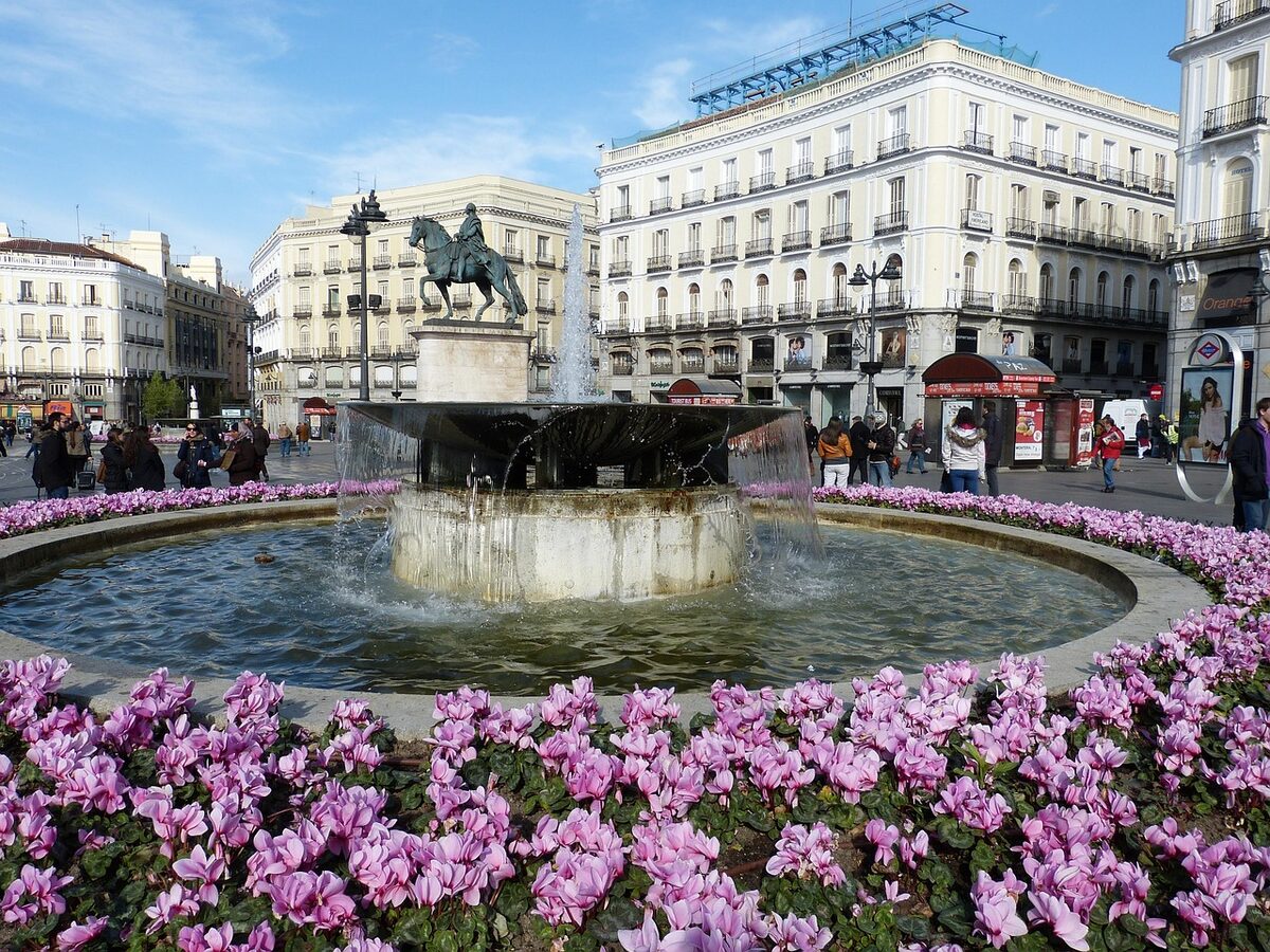 Puerta del Sol square in Madrid with equestrian statue and historic buildings