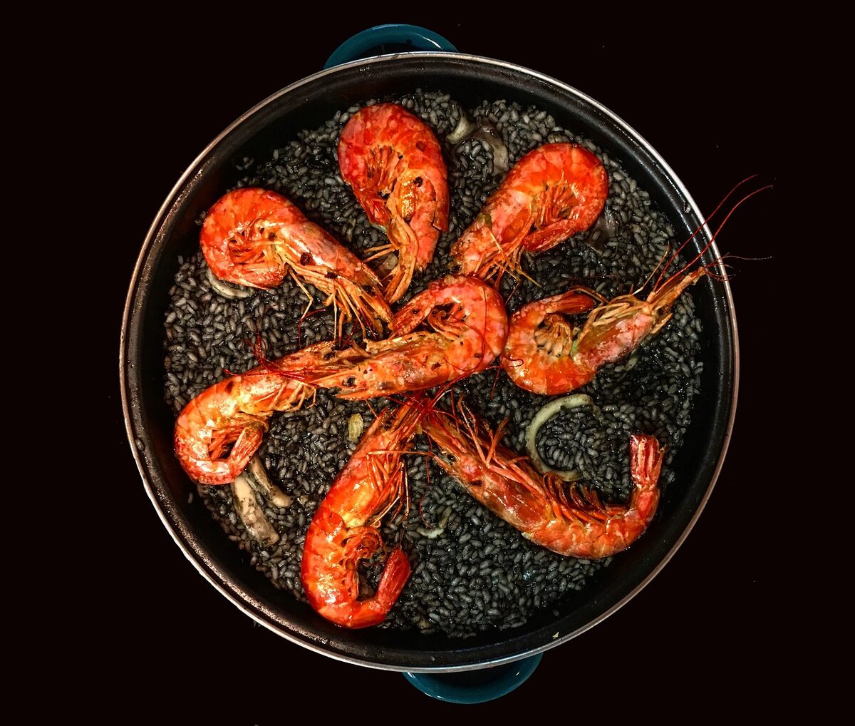 Arroz negro, black rice cooked with squid ink and seafood