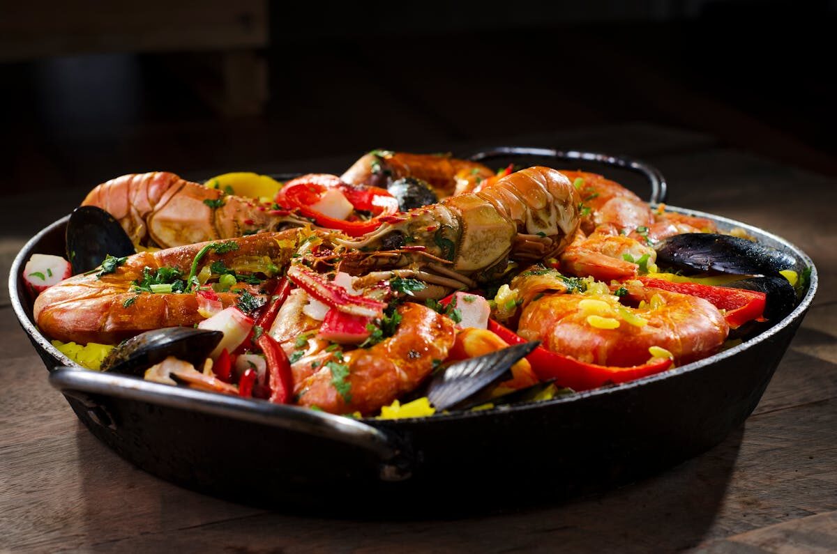 Close-up of seafood paella with shrimp, mussels, rice, and peppers