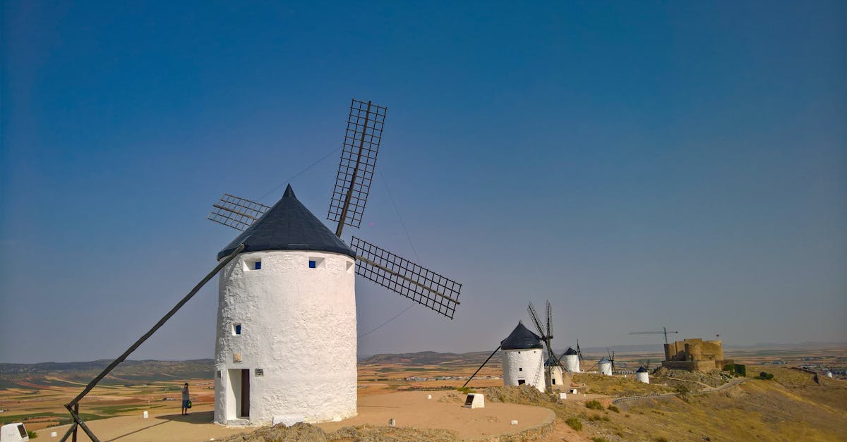 White windmills on a hill in La Mancha