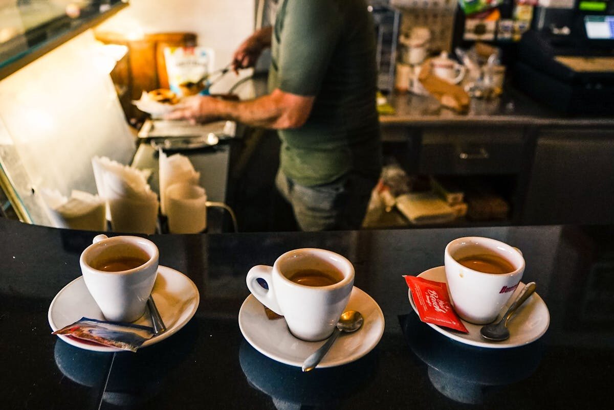 Barista preparing espresso drinks at a Spanish cafe counter