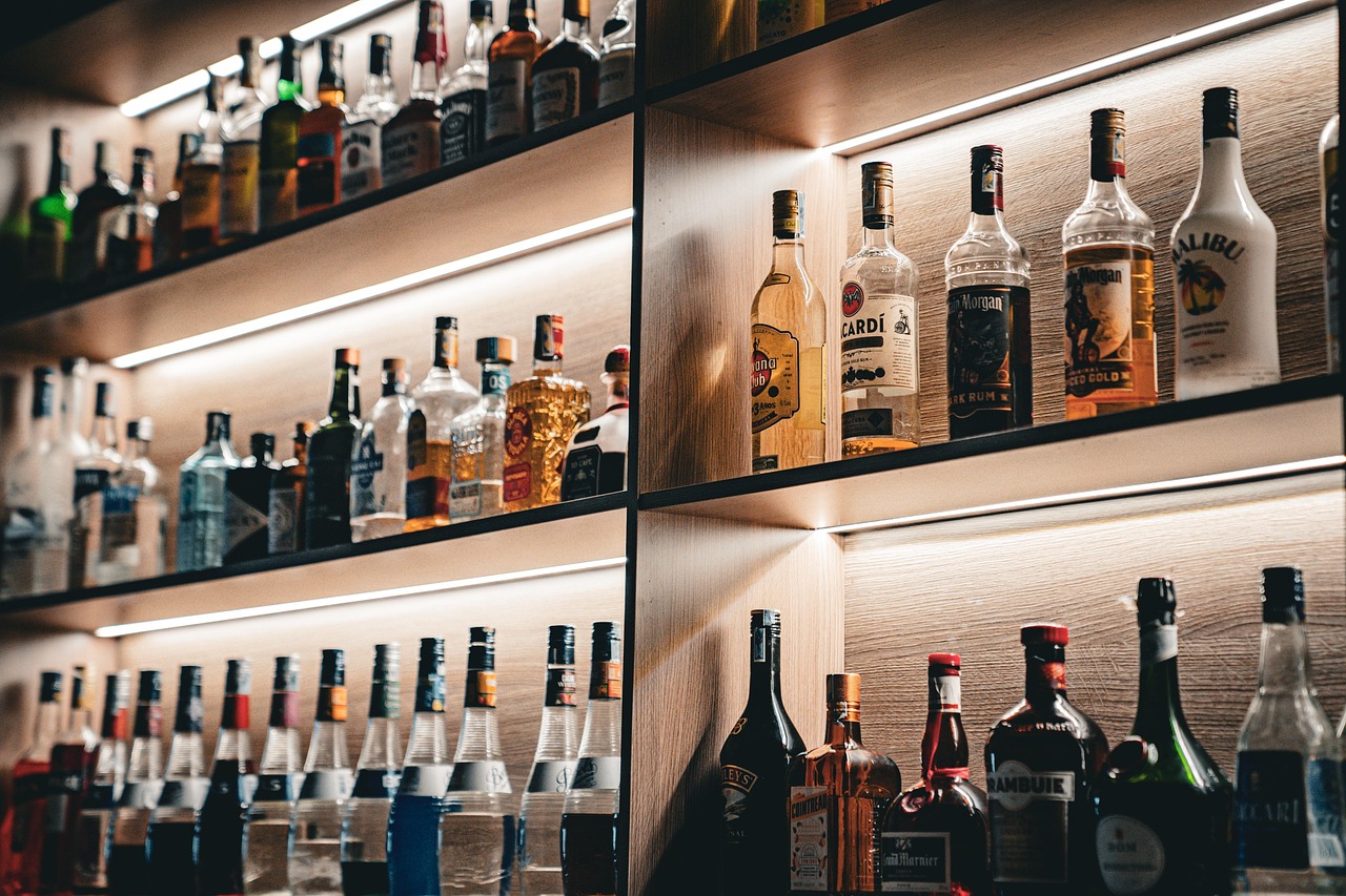 Rows of wine and liquor bottles behind a Spanish bar counter