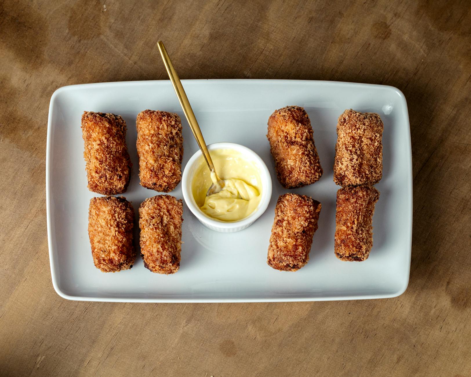 Crispy golden Spanish croquetas de jamon served on a tray