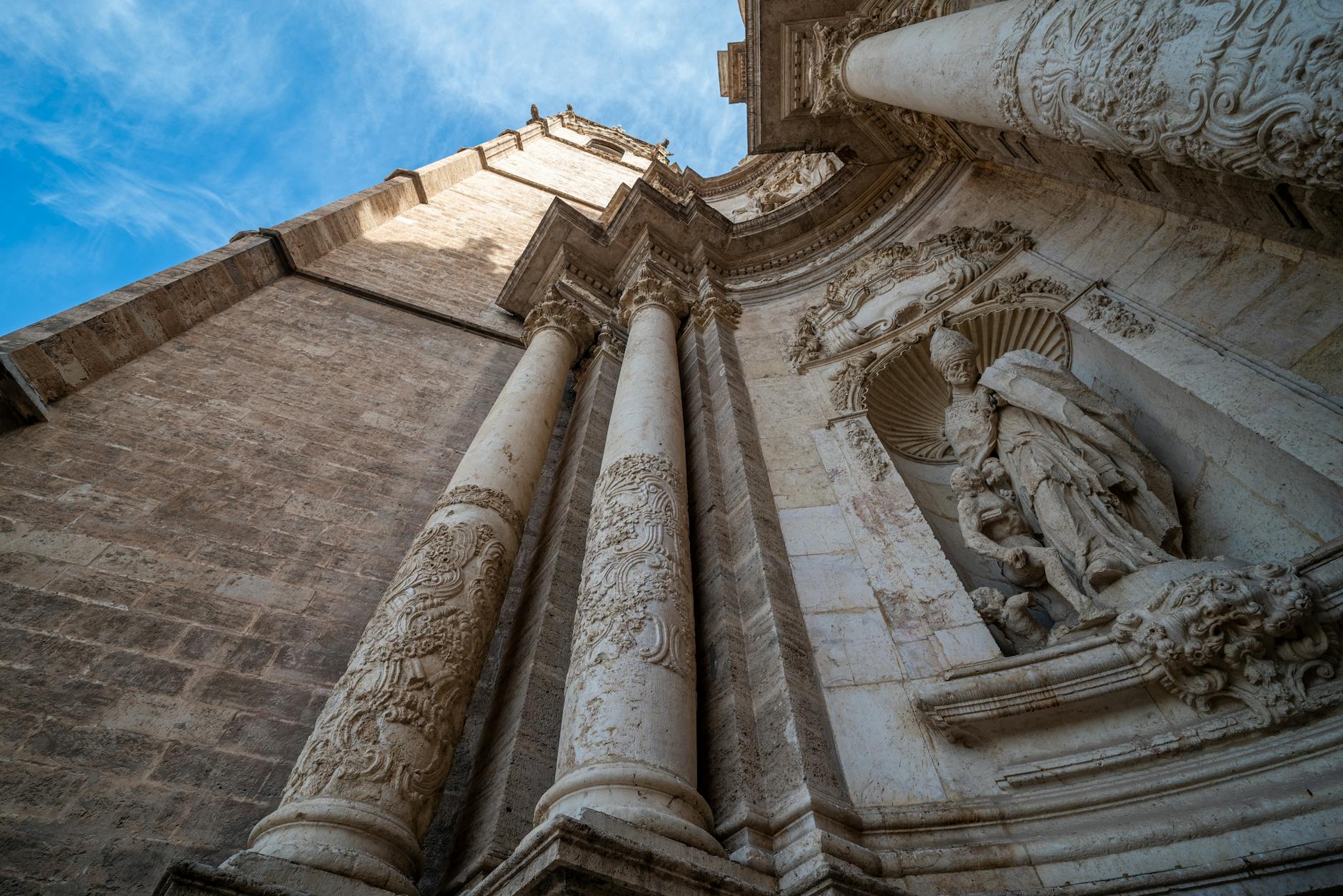 Detailed stone carvings and Gothic architecture on the facade of Valencia Cathedral