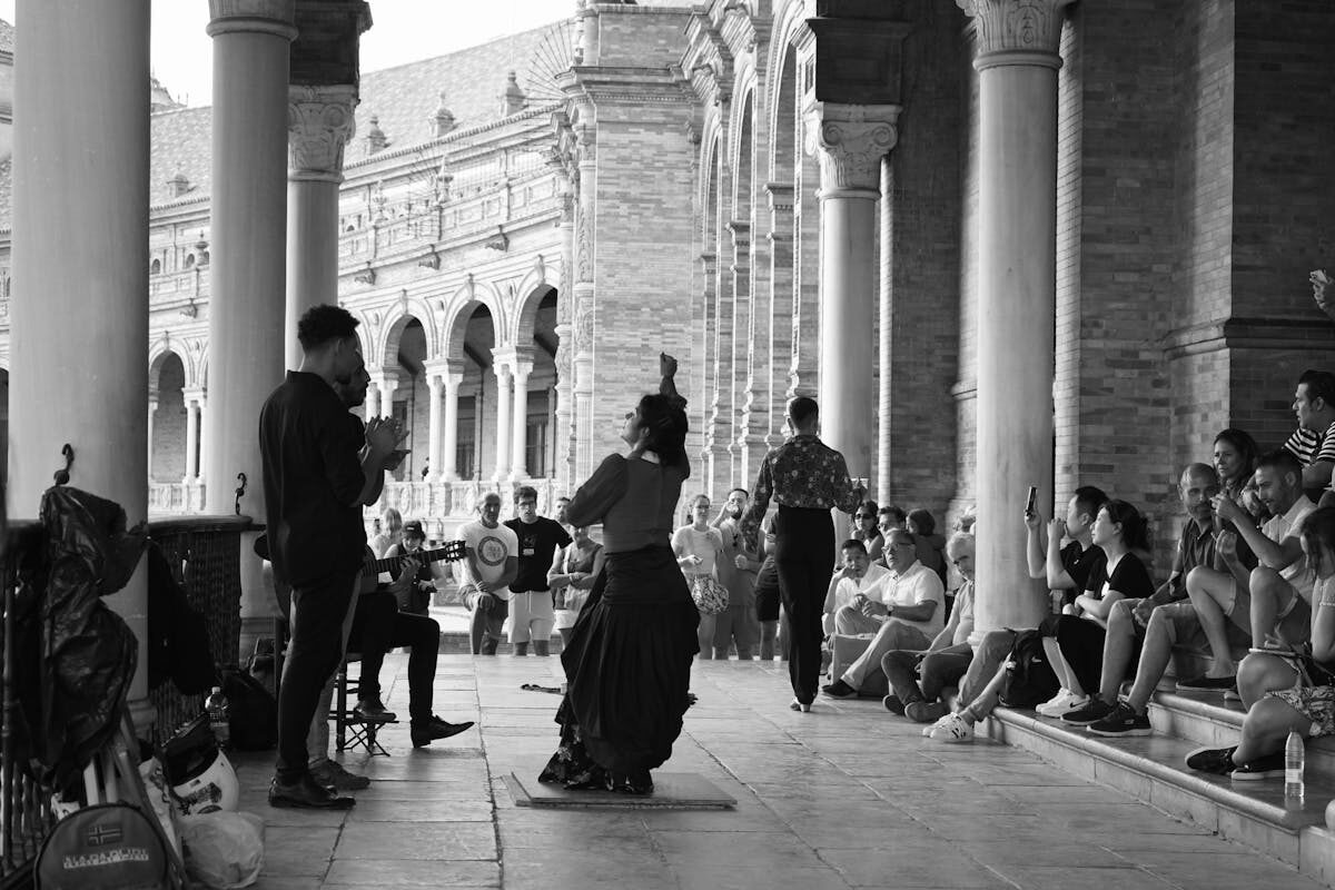 Traditional flamenco dancers in colorful dresses performing at Plaza de Espana Seville