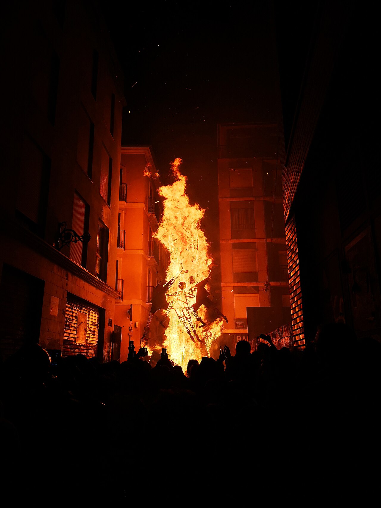 A falla sculpture engulfed in flames during the Crema on the final night of Las Fallas