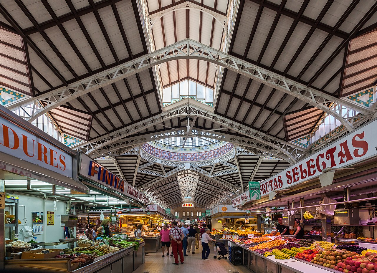 Interior view of Mercado Central Valencia showing the grand stained glass dome and iron architecture