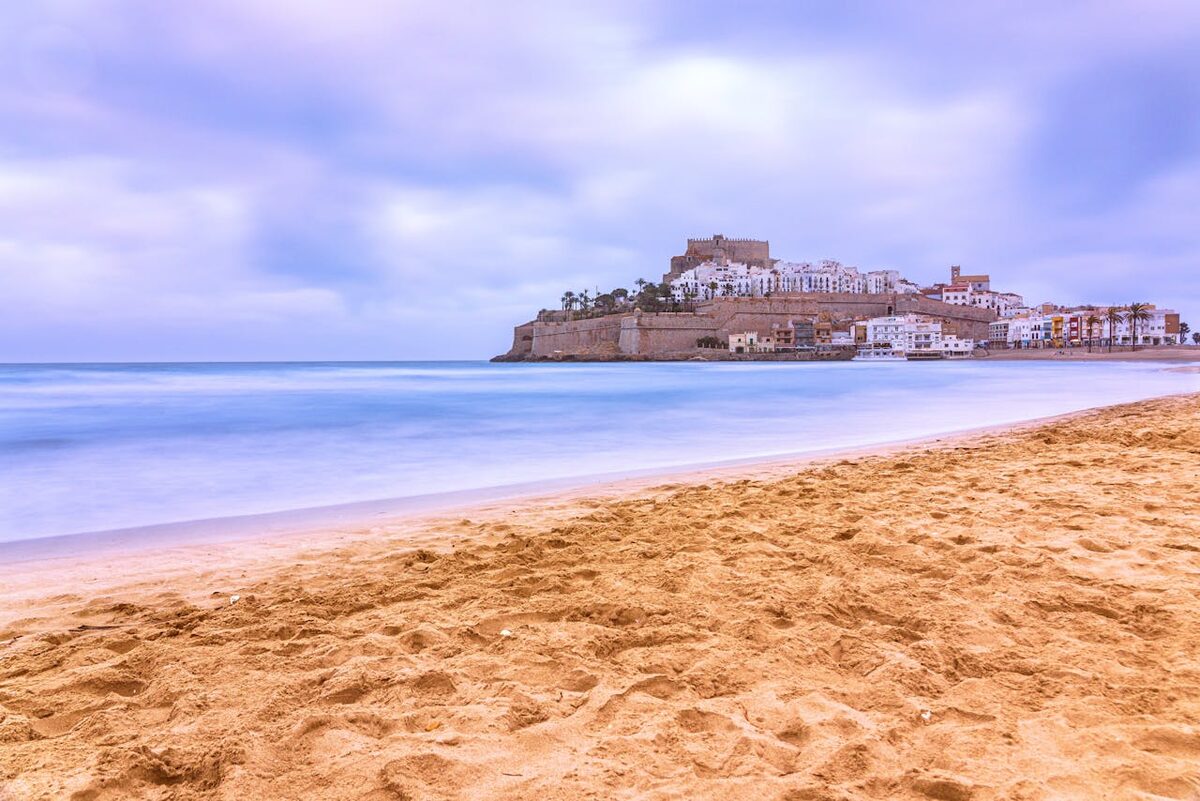 Stunning coastline view of Peniscola beach with the historic castle in the background