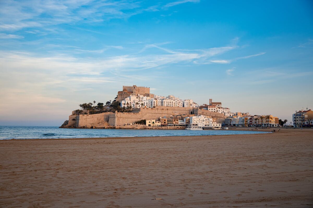 Peniscola castle overlooking the sandy beach and blue Mediterranean Sea in Spain
