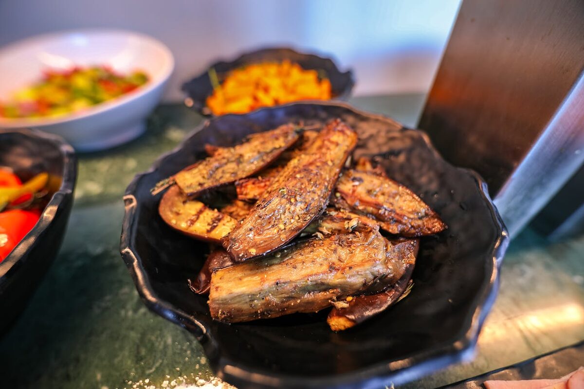 Close-up of Moroccan-style grilled eggplant dish on a buffet table