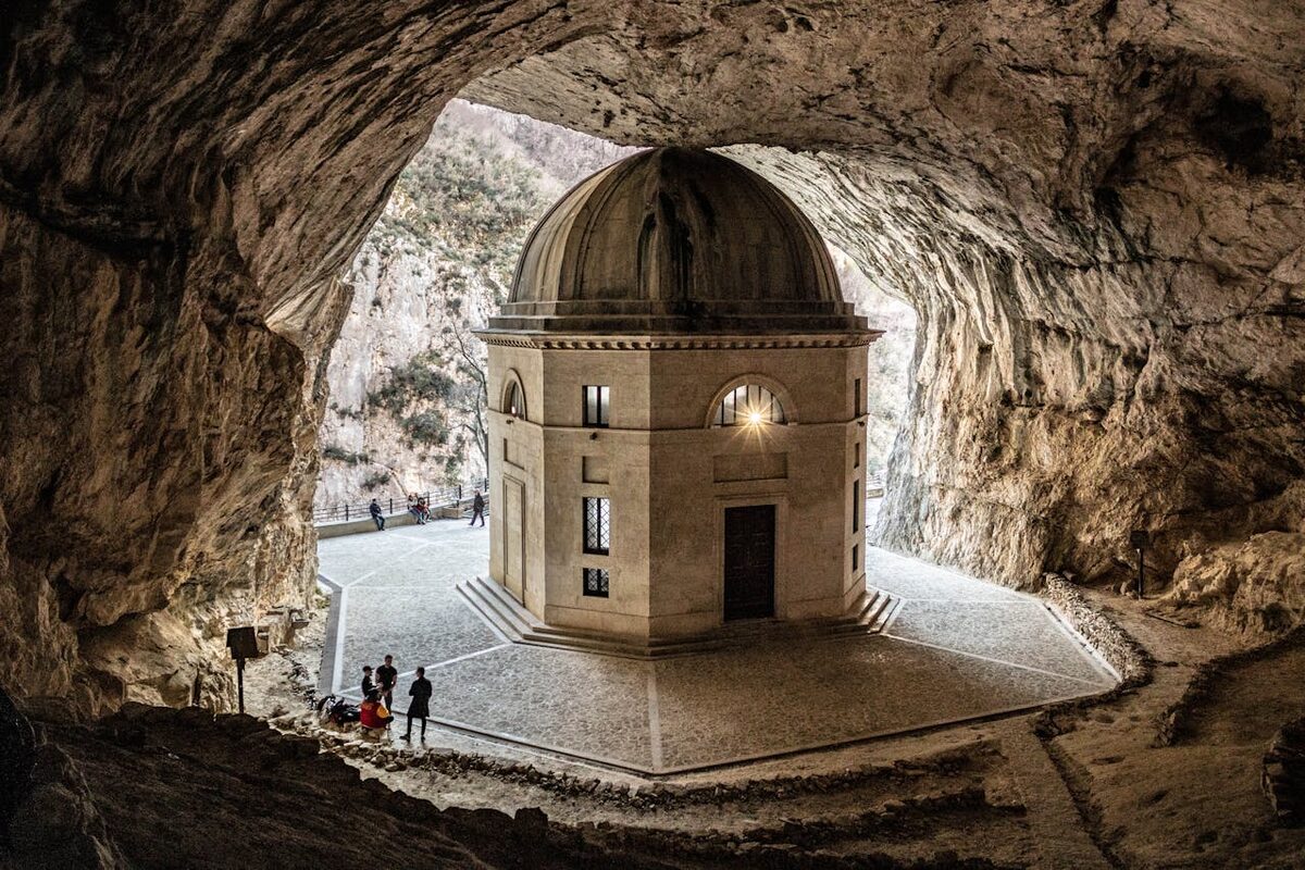A sanctuary church built inside a natural cave opening in a cliff face
