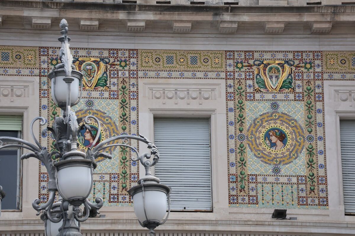 Ornate ceramic tile mosaics decorating the exterior of a Mediterranean building