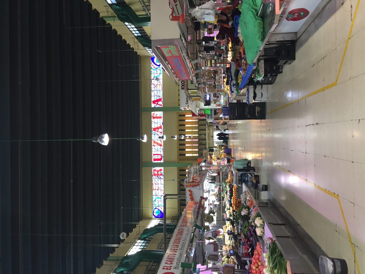 Market stalls and vendors inside the Mercado de Ruzafa neighborhood market in Valencia
