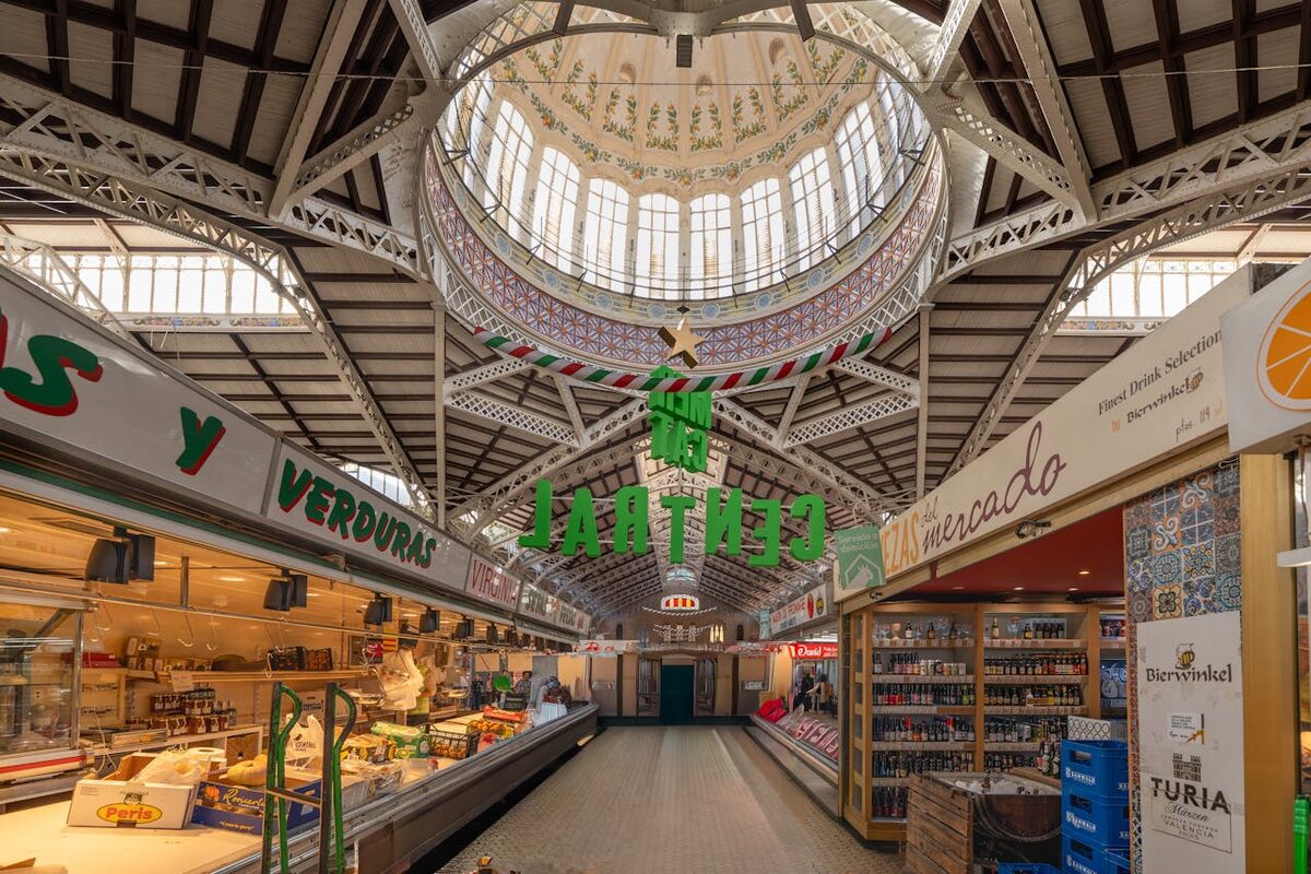 Arched ceiling and iron framework inside a historic Valencia market building